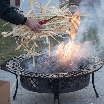 Burning palms for Ash Wednesday - Arlington Catholic Herald