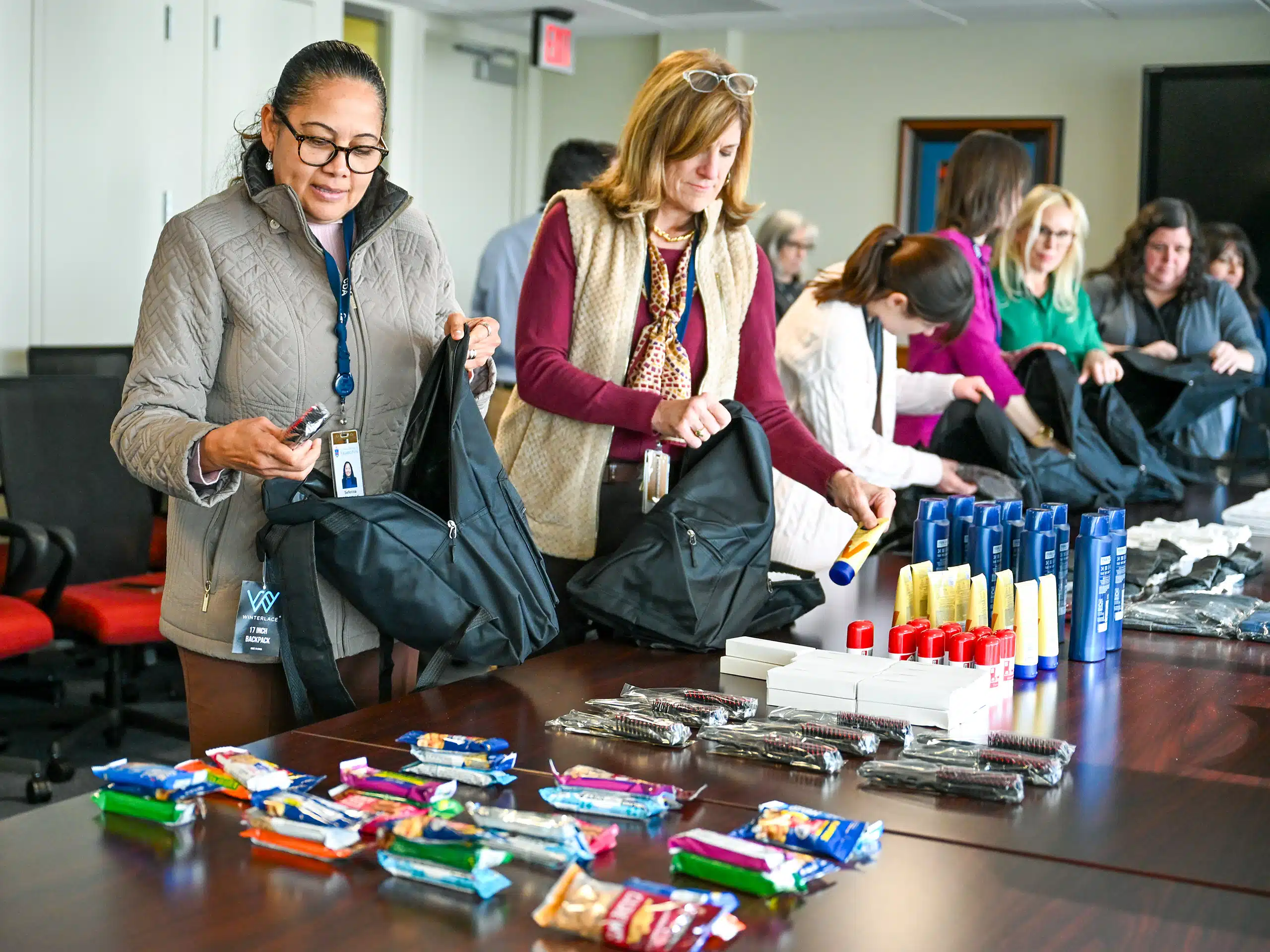 Diocesan staff fill backpacks for individuals transitioning from ...