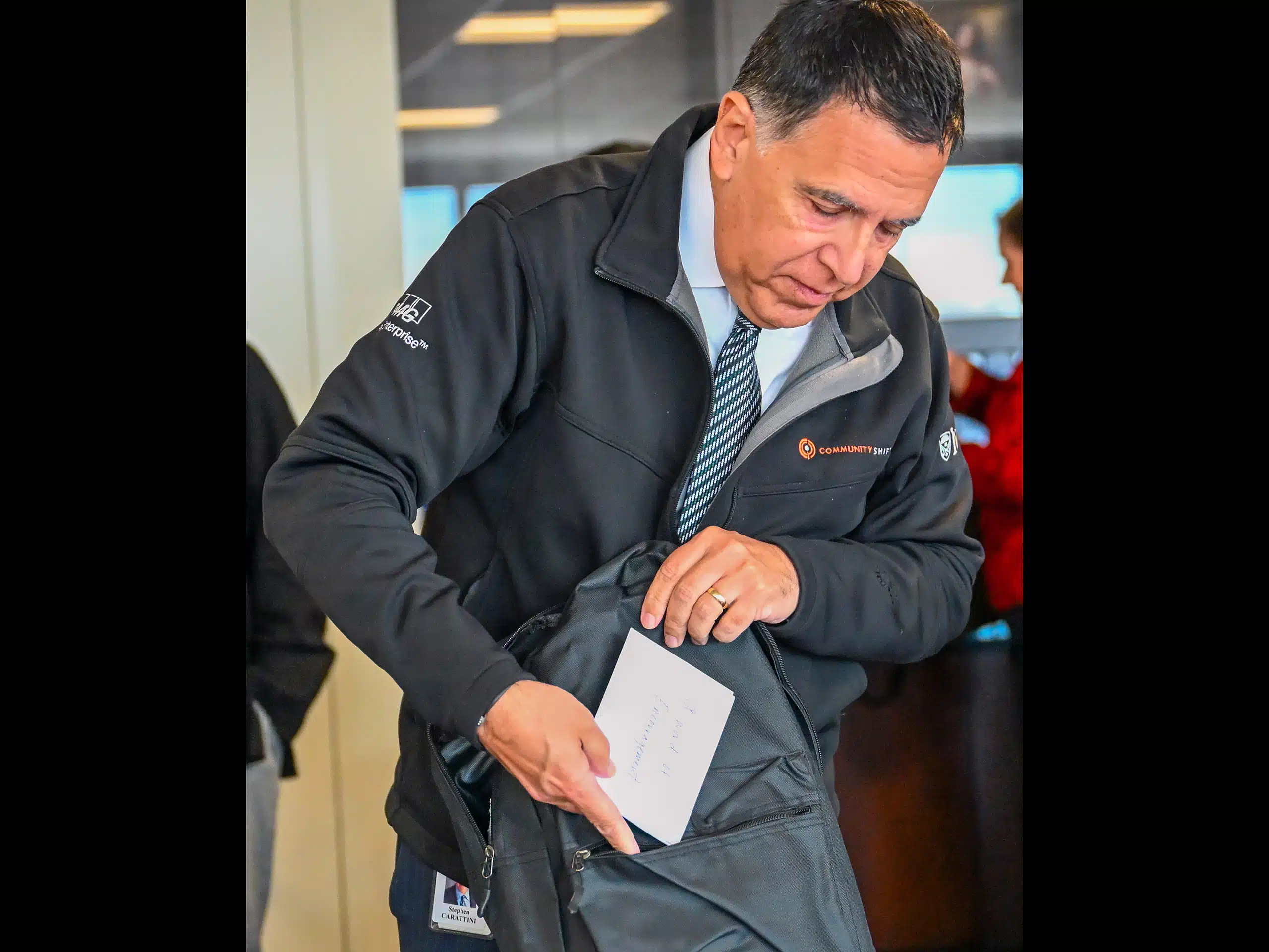 Diocesan staff fill backpacks for individuals transitioning from ...